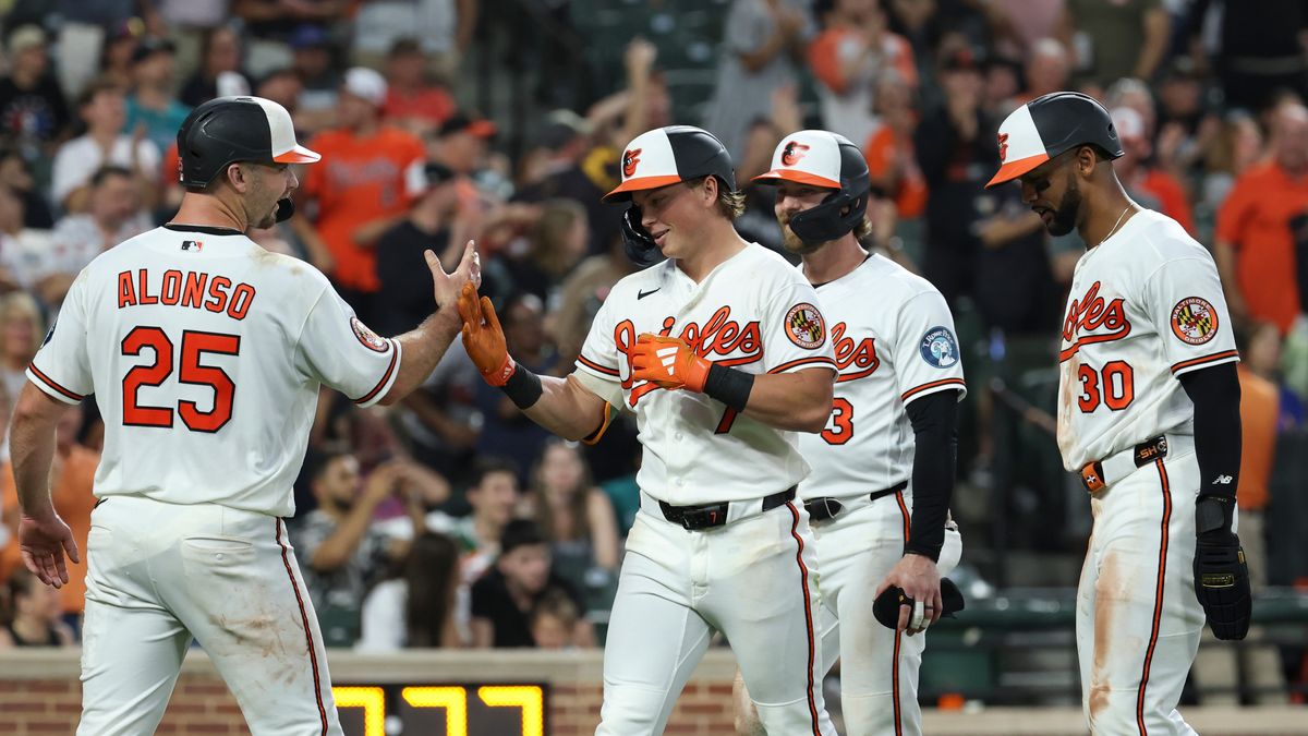 Holliday hits grand slam and Young pitches Orioles past Mariners 7-2 to ...