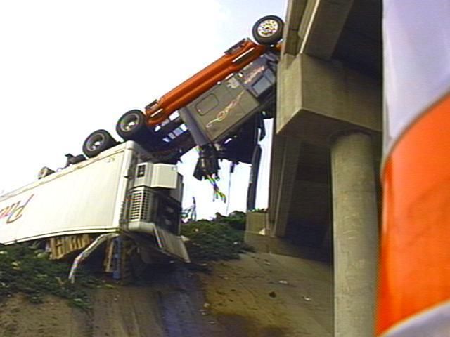 Driver Falls From Truck Hanging from Highway Overpass