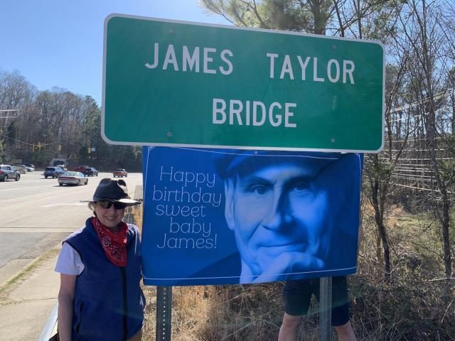 People gather beneath James Taylor Bridge in Chapel Hill to sing songs ...