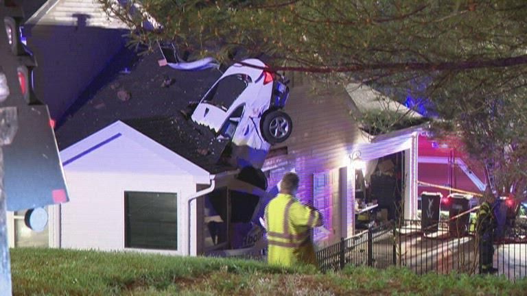 Driver crashes car through roof of home