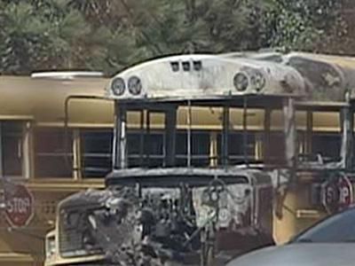Three charged with setting bus on fire