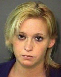 Woman charged after baby found near trash pile